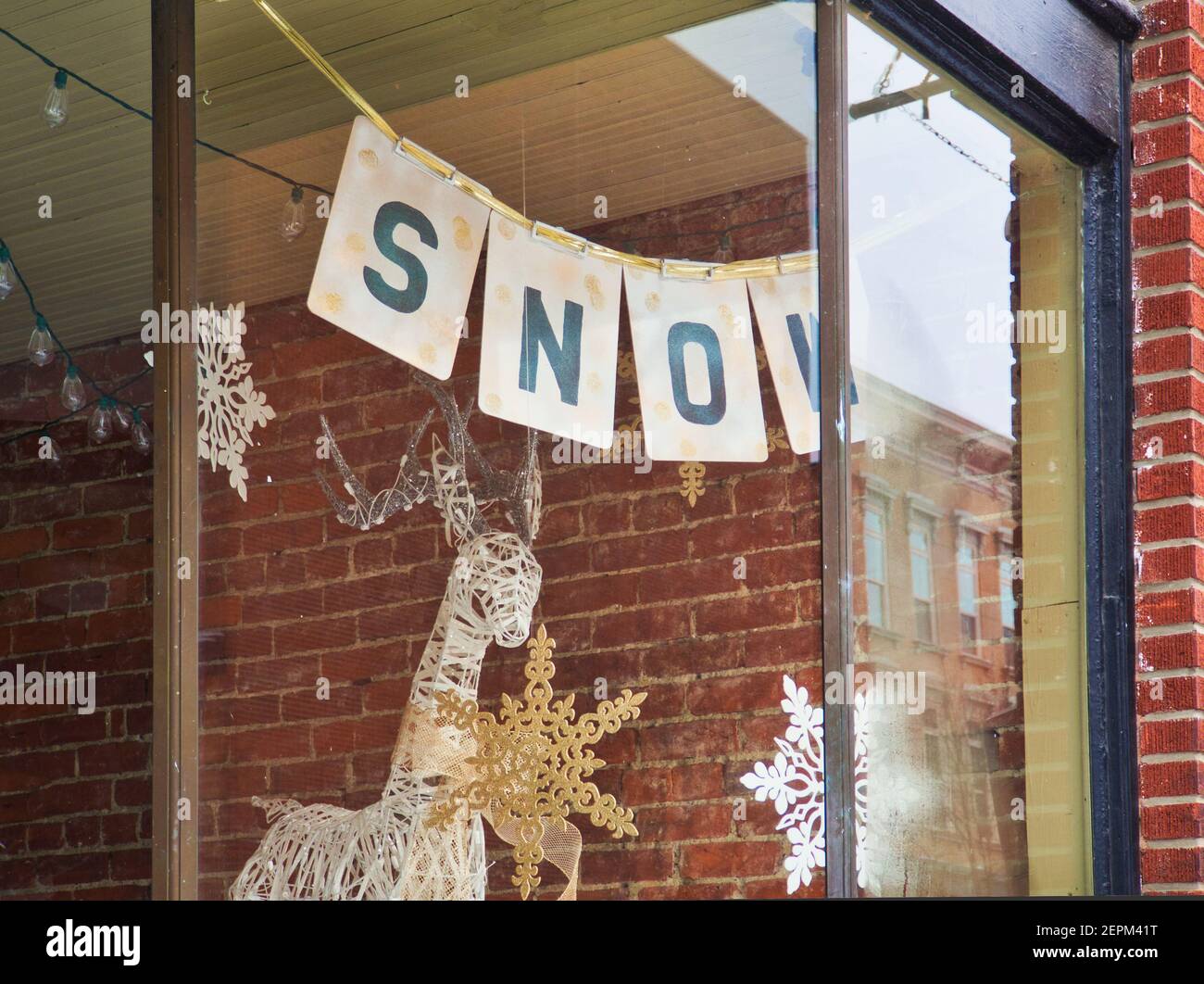 Snow sign in a store front window with a vintage look Stock Photo - Alamy