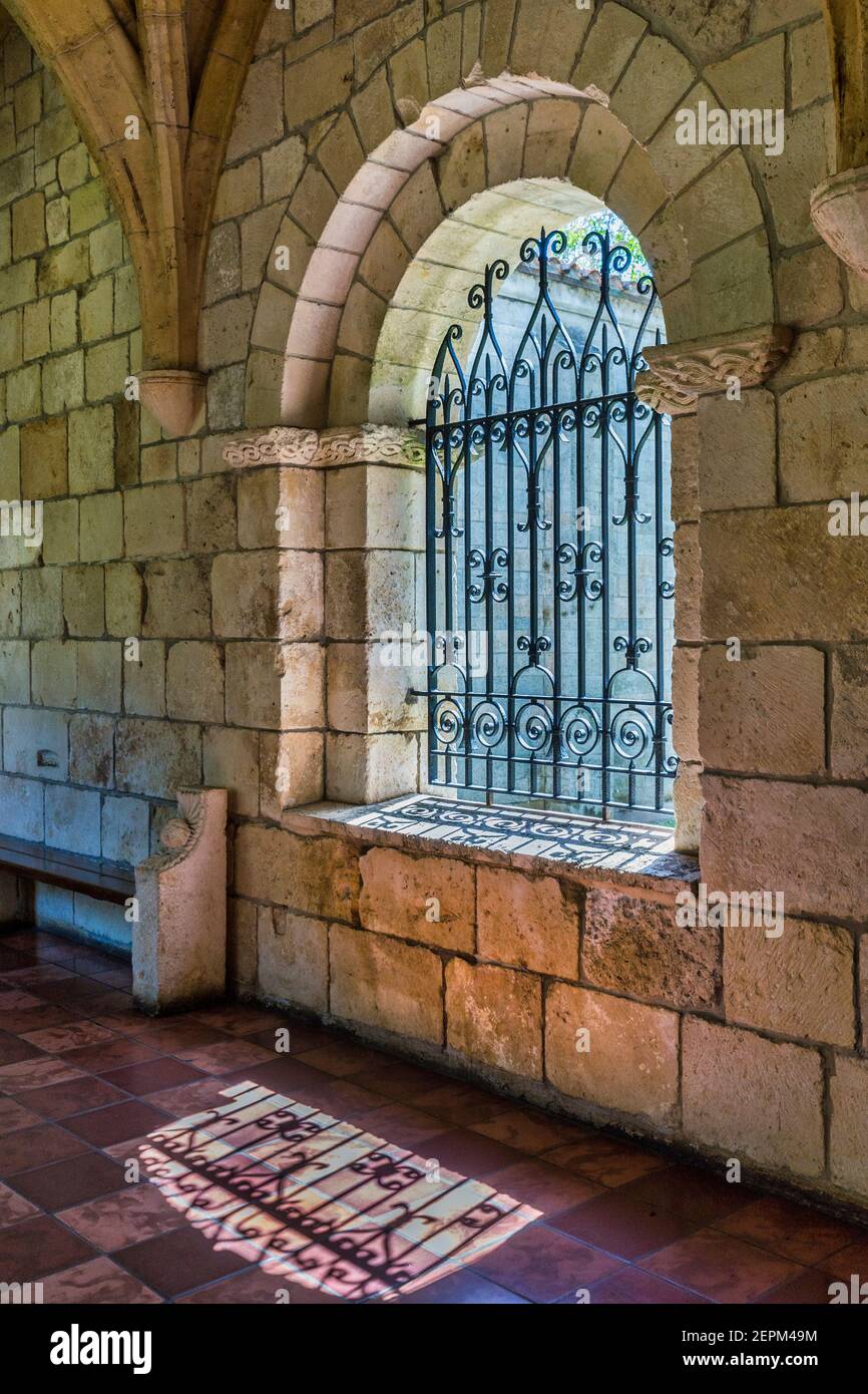 Window grill casts shadow within the cloisters of the 12th century ...