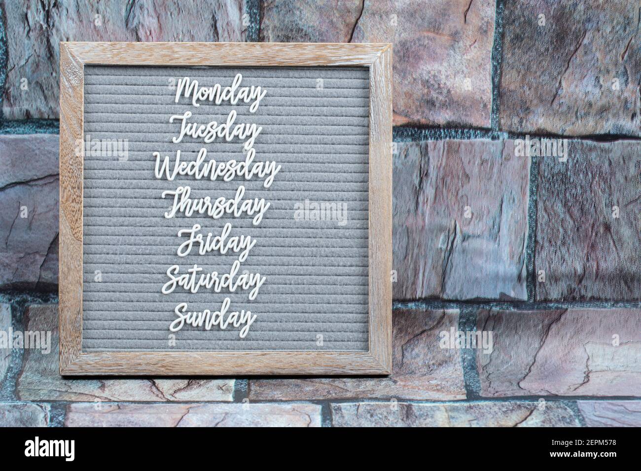 Happy weekdays poster written with letter symbols on the grey tissue ...