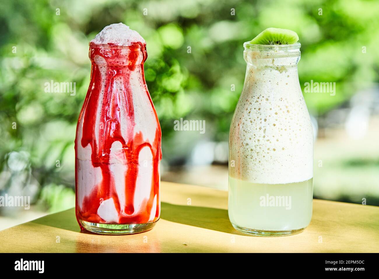 Two milkshakes on wooden table Stock Photo - Alamy