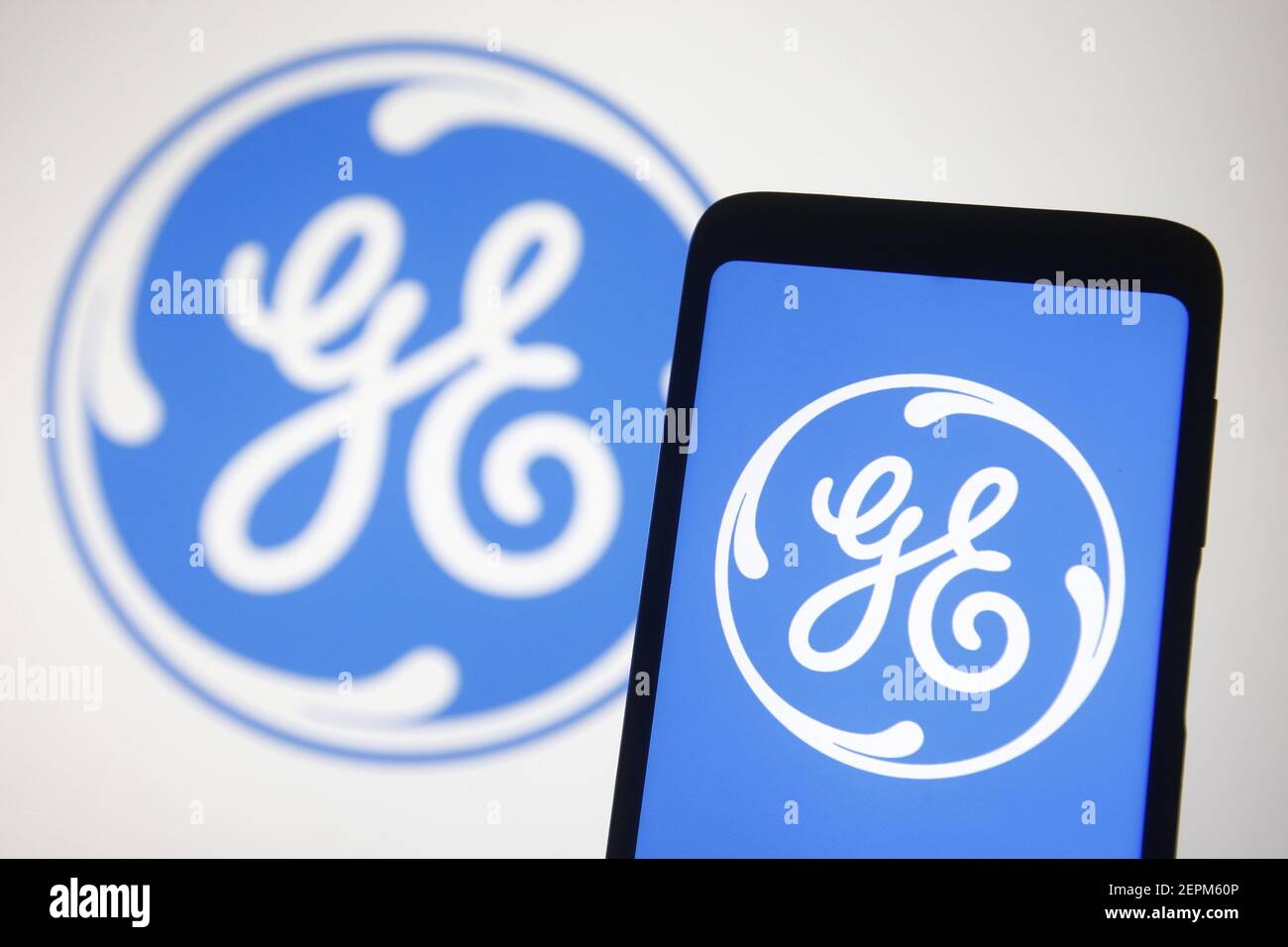 In this photo illustration a General Electric logo is seen on a ...