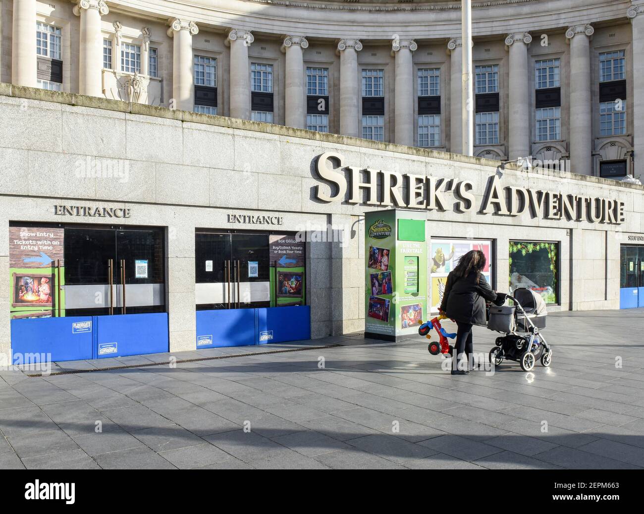 A lady walks with the pram past a closed tourist attraction Shrek's ...