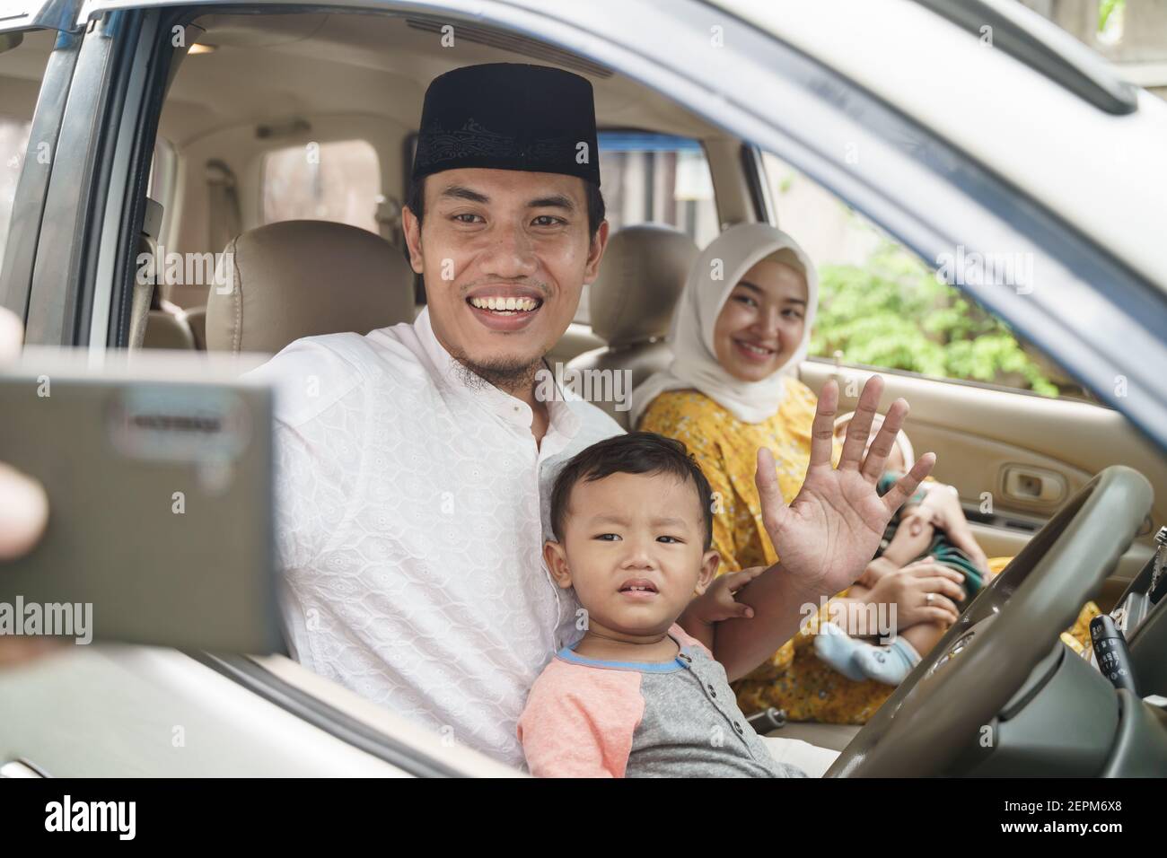 portrait of Muslim family travel by car and talk using video call on ...
