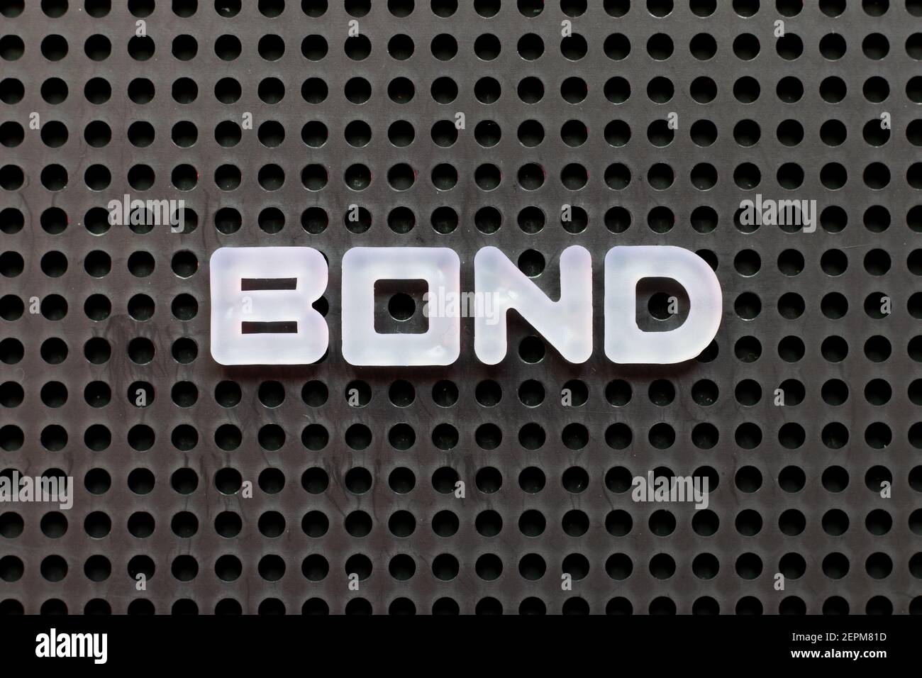 White color letter in word bond on black pegboard background Stock ...