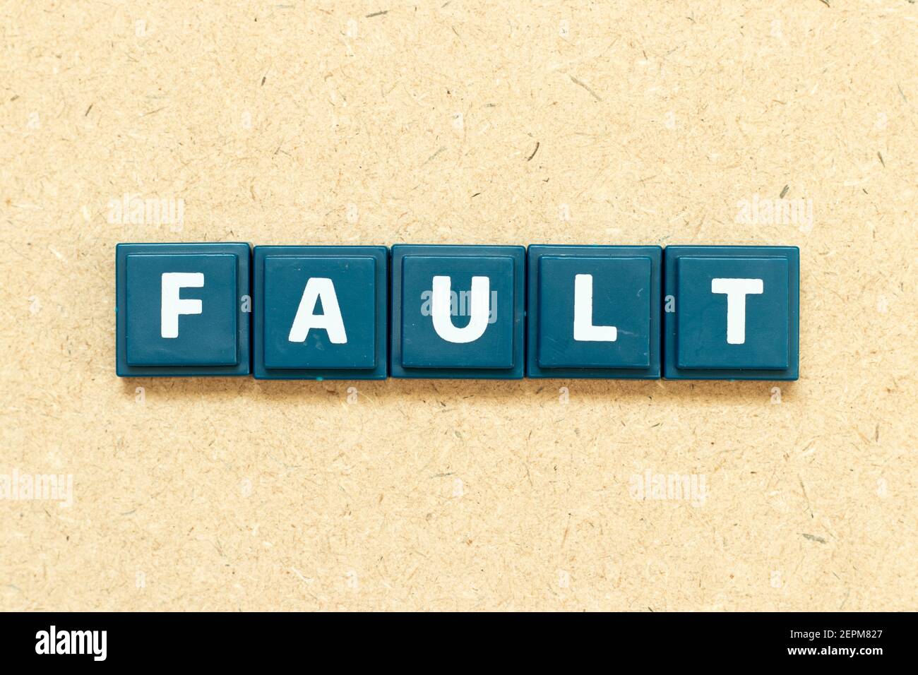 Tile alphabet letter in word fault on wood background Stock Photo - Alamy