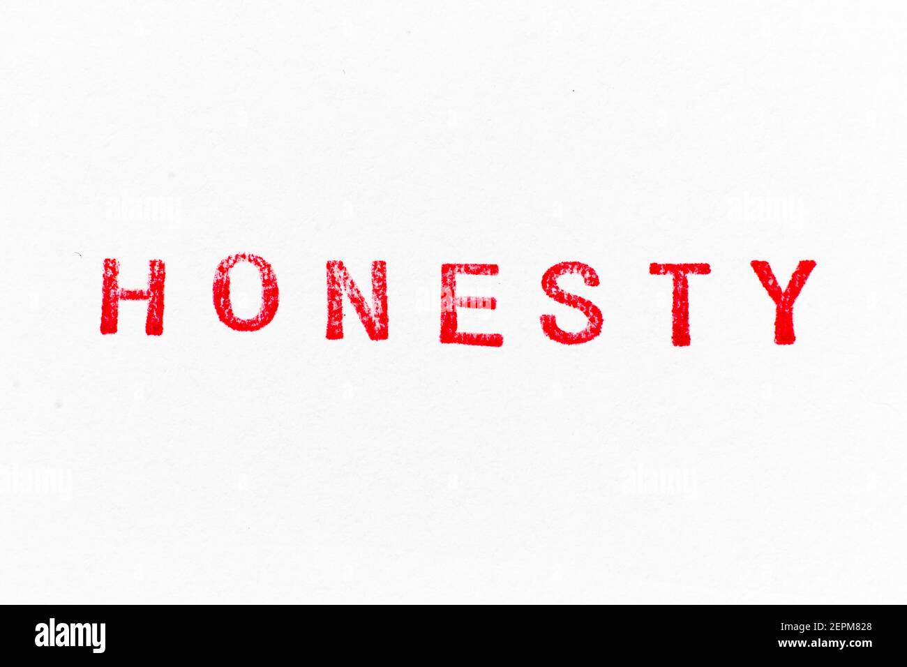 Red color ink rubber stamp in word honesty on white paper background ...
