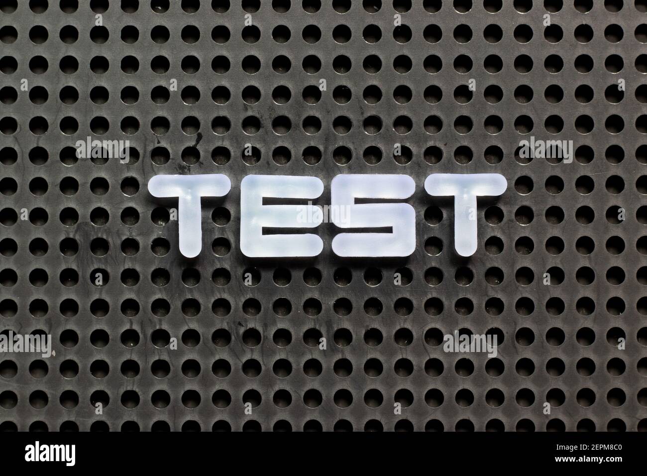 White color letter in word test on black pegboard background Stock ...