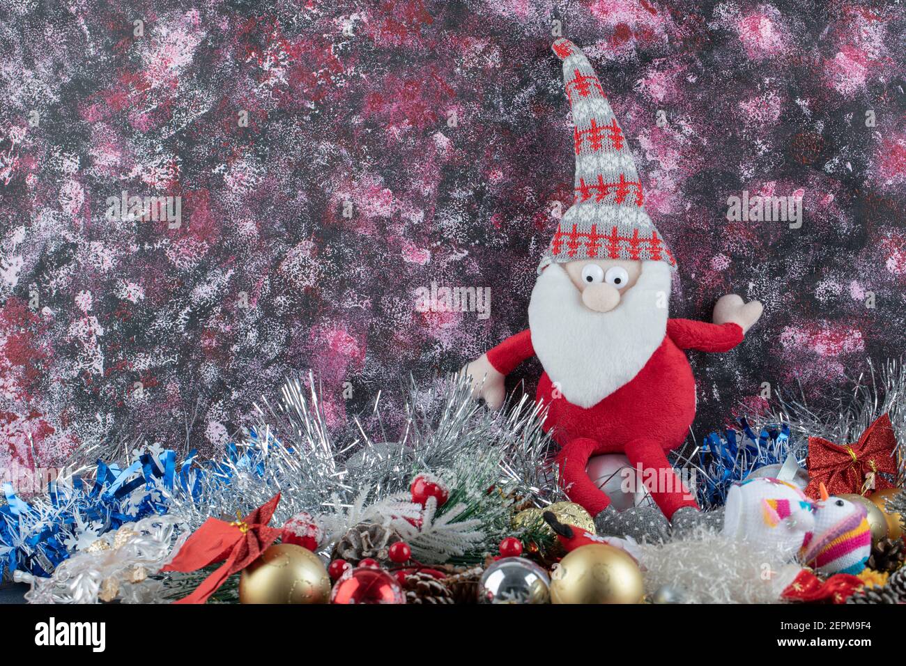 Small Santa figurine and baubles on colorful background Stock Photo - Alamy