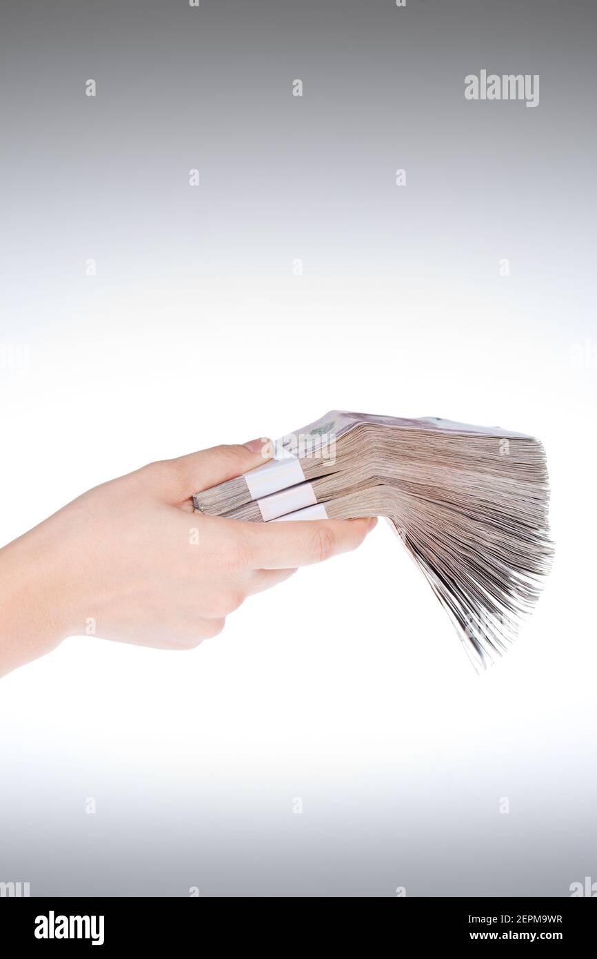 Hand holding stacks of banknotes Stock Photo - Alamy
