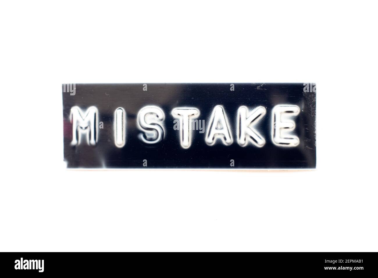 Embossed letter in word mistake on black banner with white background ...