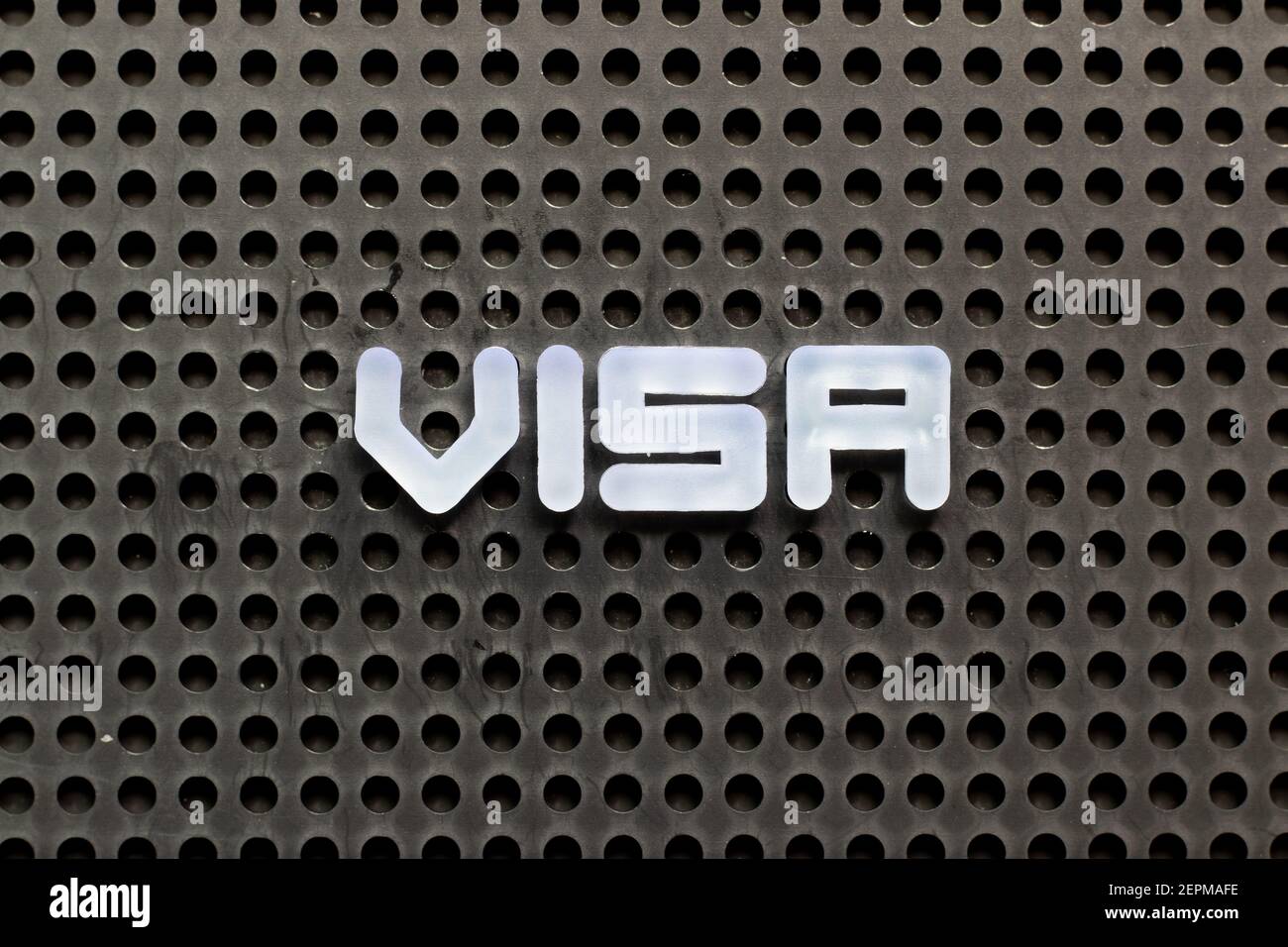 White color letter in word visa on black pegboard background Stock ...