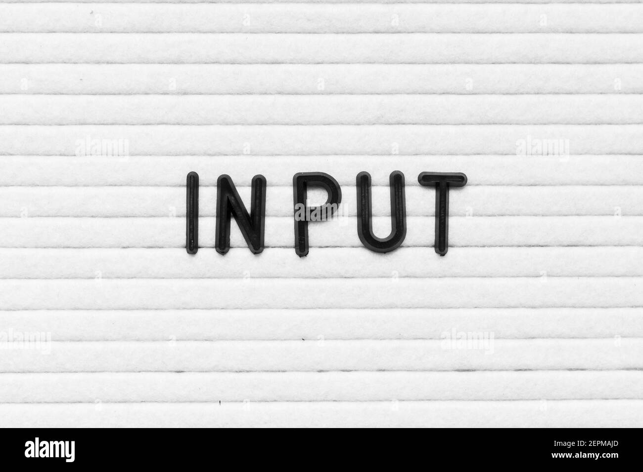 Black color letter in word input on white felt board background Stock ...