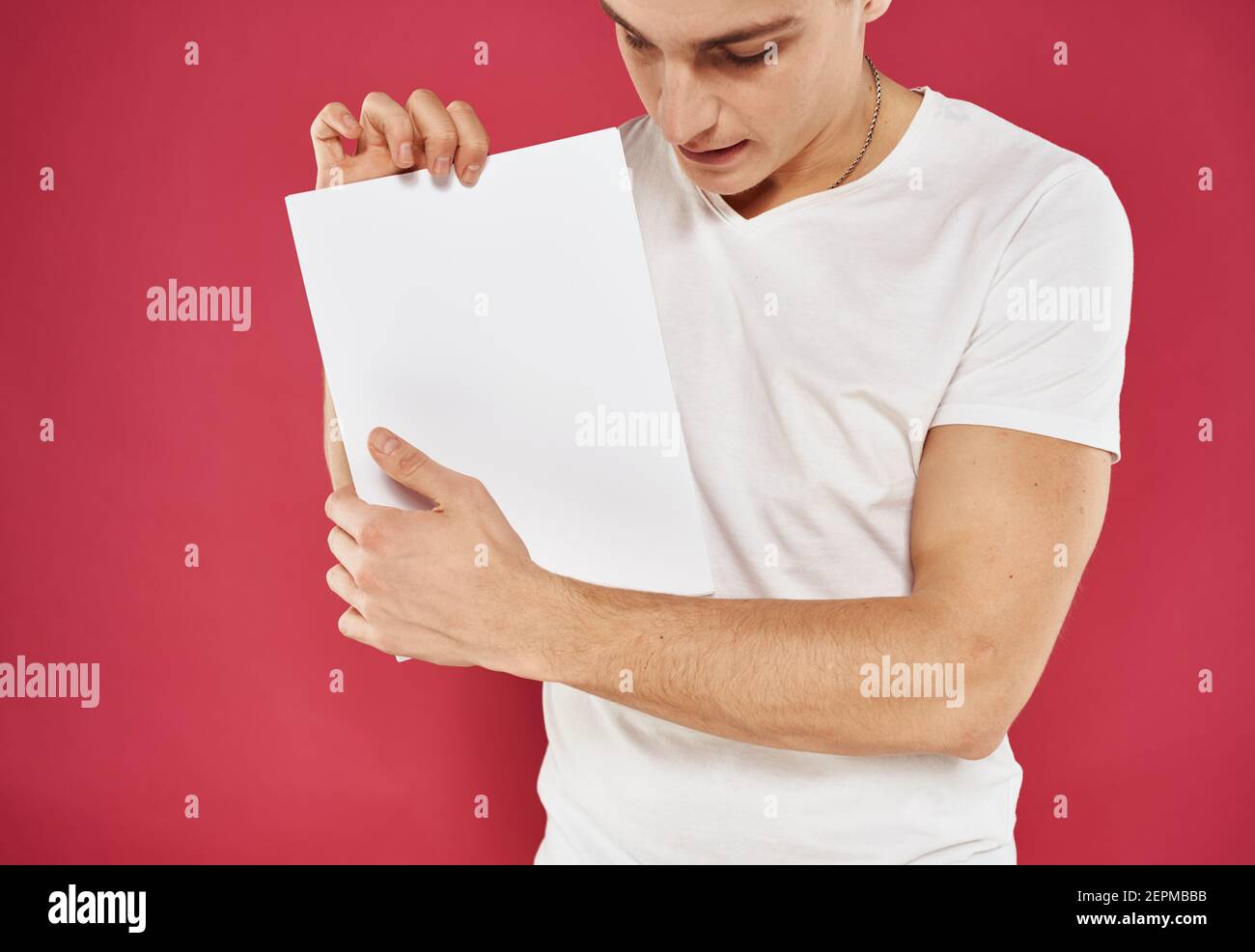 Guy advertises flyer on red background and mockup Copy Space Stock ...