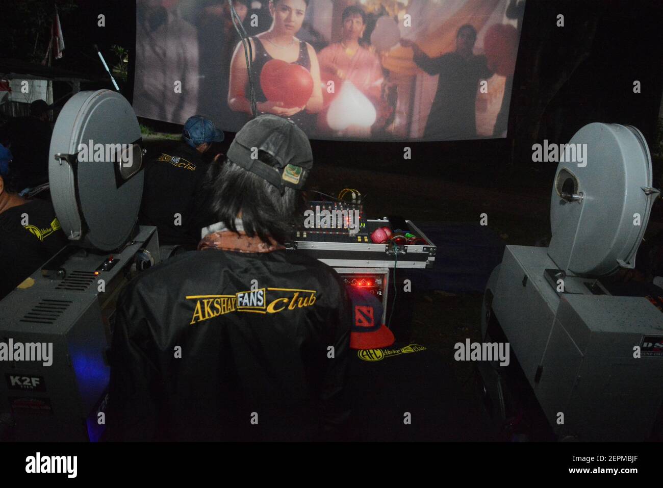 A man from The Indonesian community of Layar Tancap Indonesia installed the film projector ...