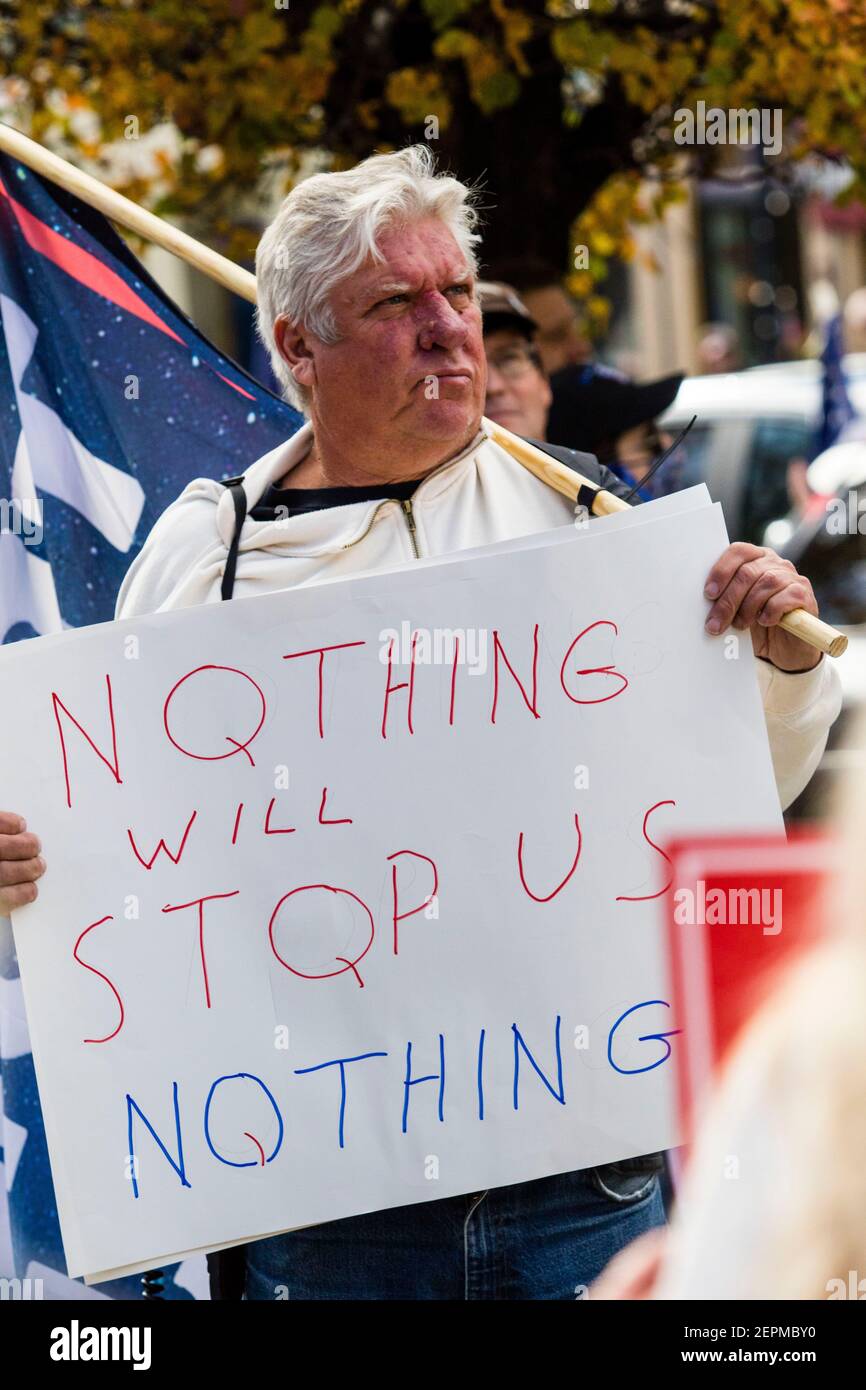 A Qanon believer holding a placard as pro Trump protestors gathered at ...