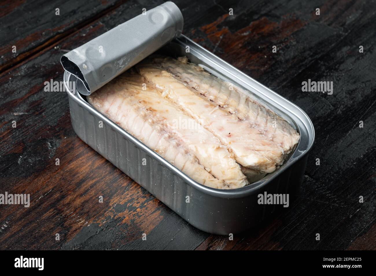 Canned Mackerel Fillets in Tin set, in tin can, on old dark wooden ...