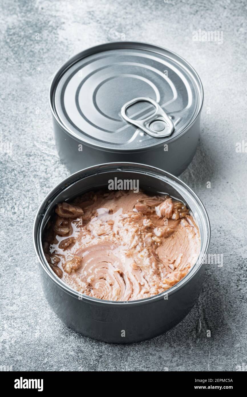 Tuna in a can, whole and chopped set, in tin can, on gray background ...