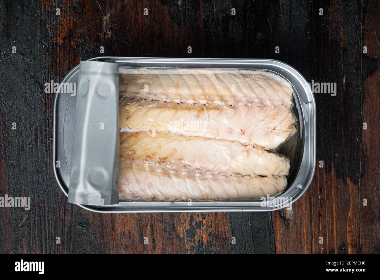 Canned Mackerel Fillets in Tin set, in tin can, on old dark wooden ...