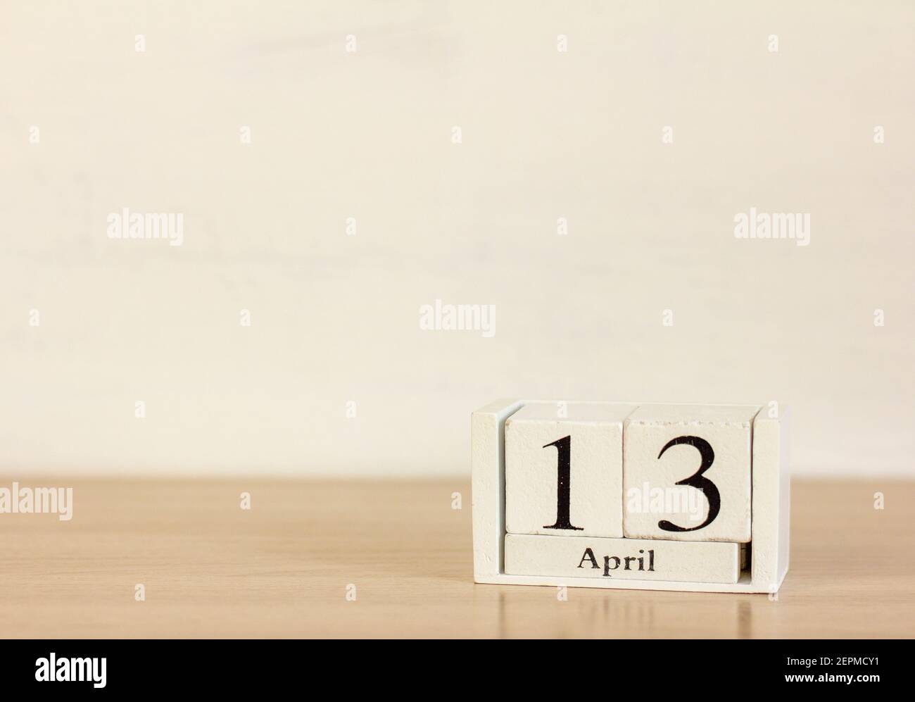 A wooden calendar with the date April 13 on the desktop Stock Photo - Alamy