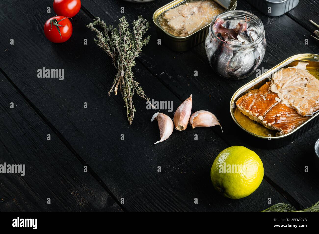 Assortment of cans of canned with different types of fish set, on black ...