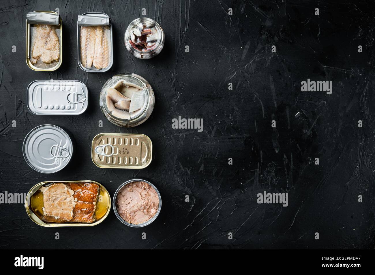 Assortment of cans of canned with different types of fish set, on black ...