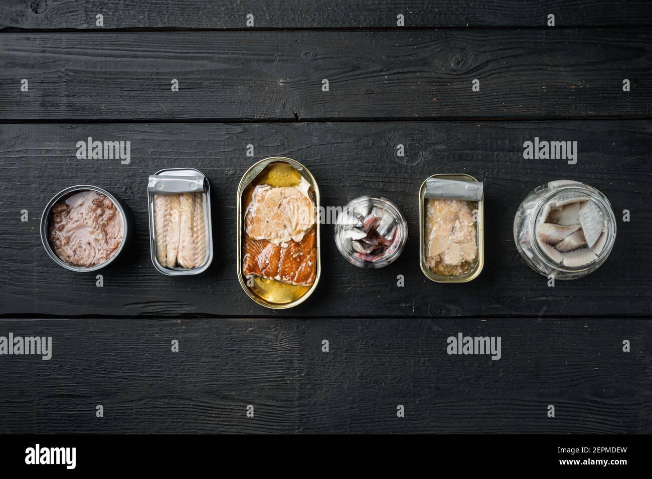 Assortment of cans of canned with different types of fish set, on black ...