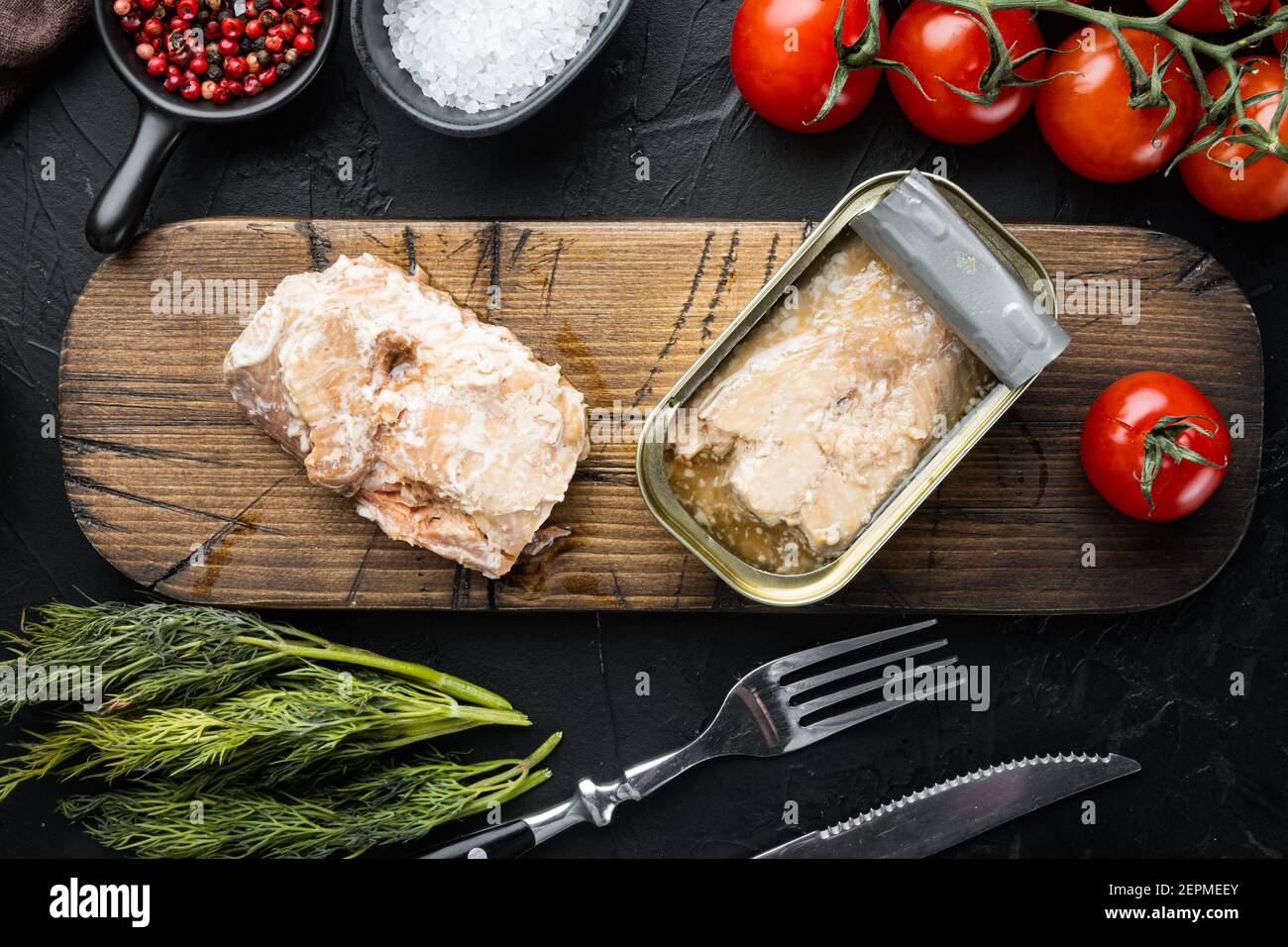 Canned wild Trout set, on wooden cutting board, on black background ...