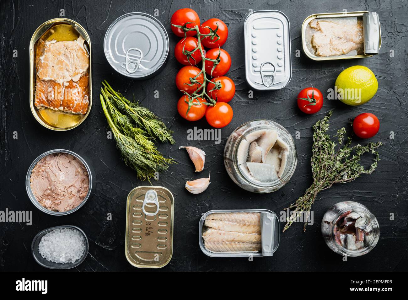 Assortment of cans of canned with different types of fish set, on black ...