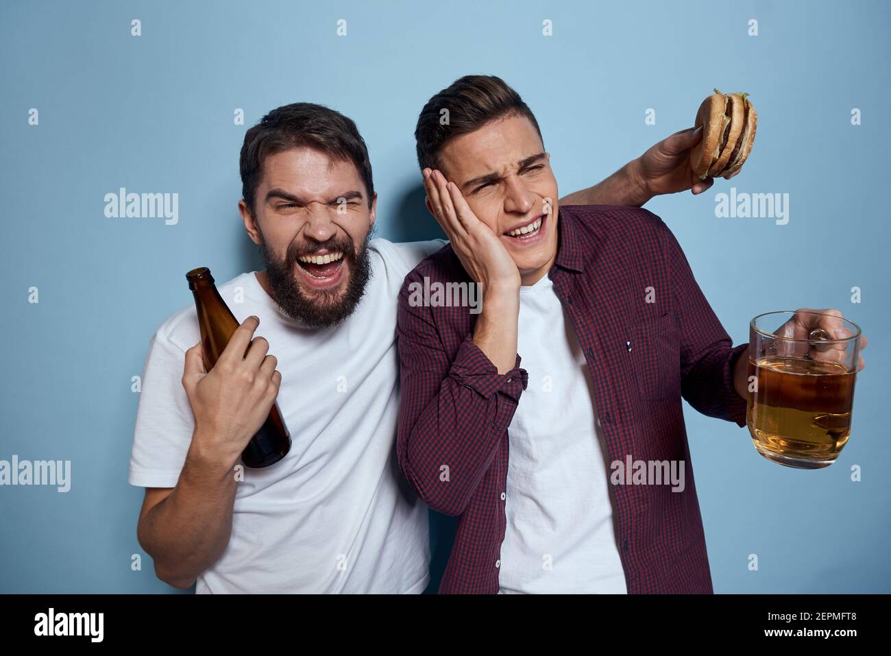 two friends with beer fun entertainment lifestyle blue background Stock ...