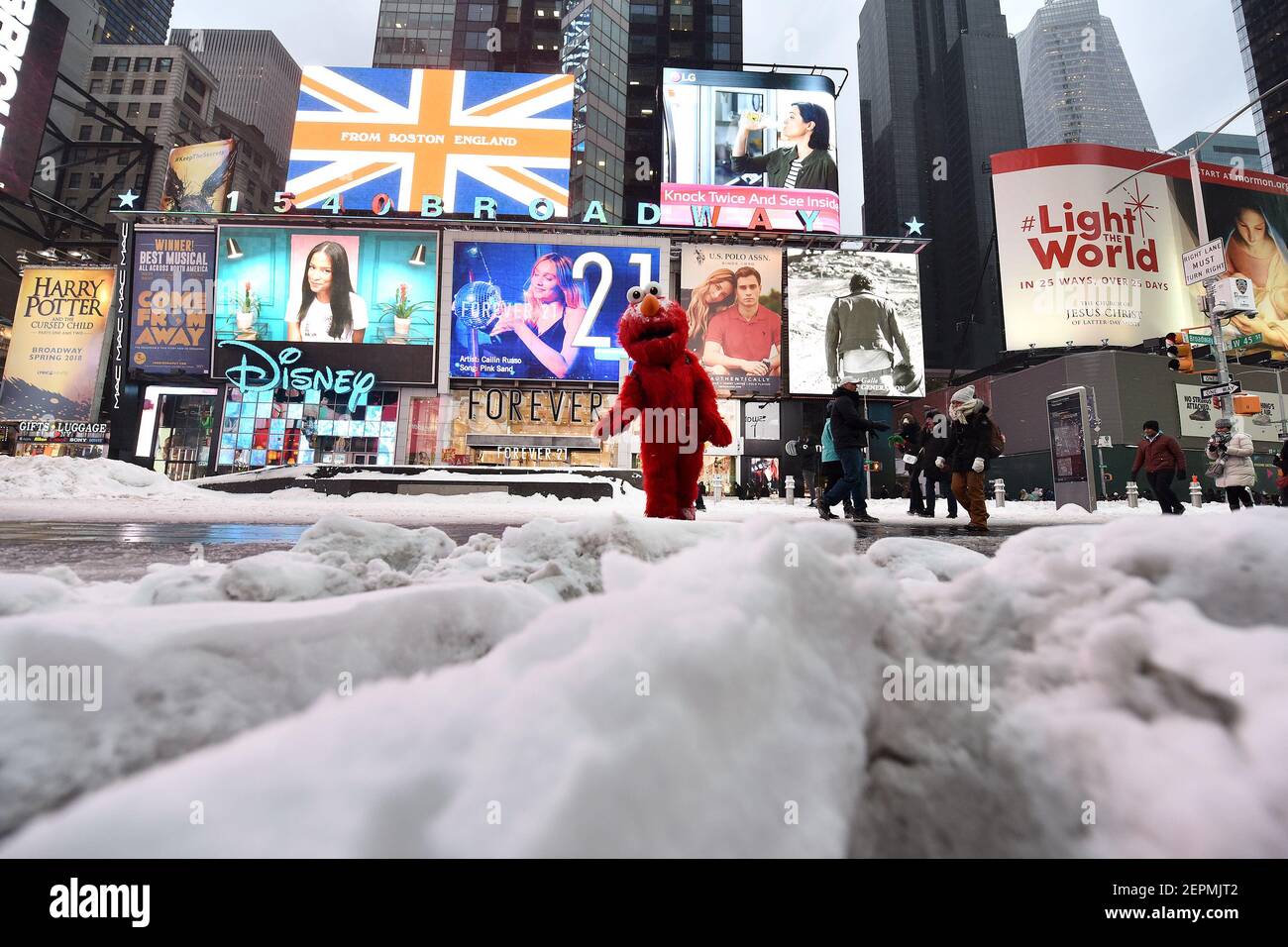 A sole Times Square busker wearing an Elmo costume looks for customers ...