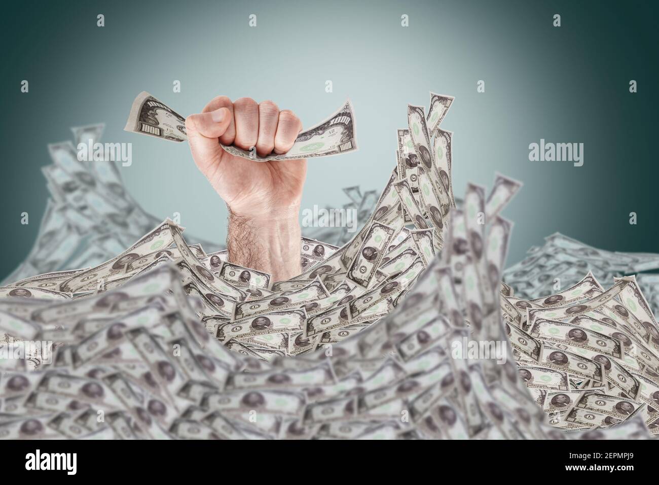A man's hand clenched in a fist a banknote peeking out from a large ...