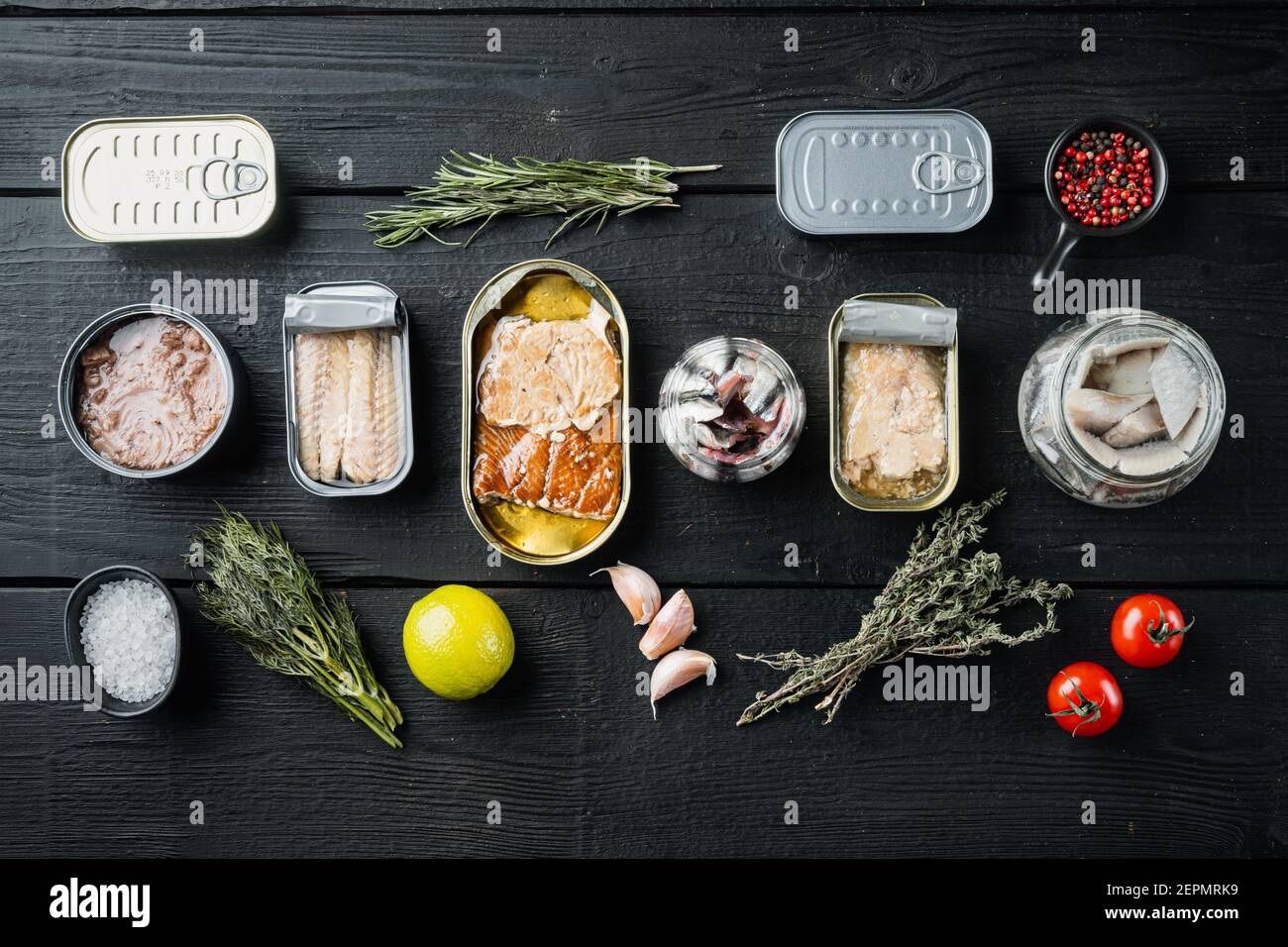 Assortment of cans of canned with different types of fish set, on black ...