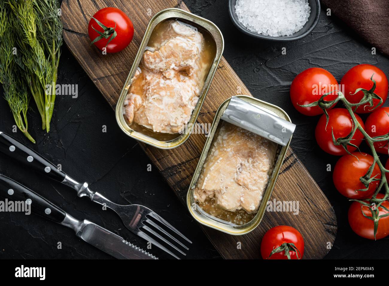 Canned wild Trout set, on wooden cutting board, on black background ...