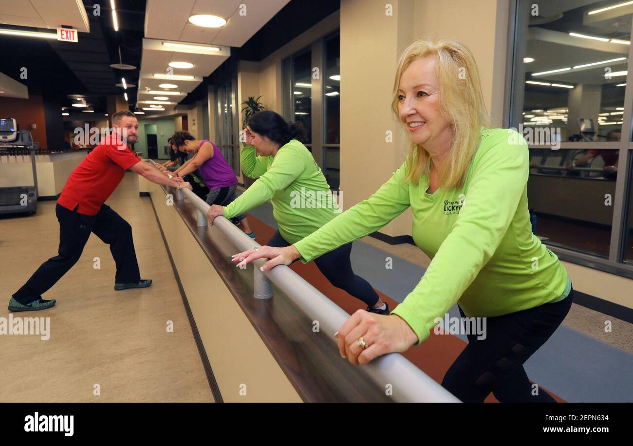 Beth Thorp, at right, stretches with other members of the "Lucky 13 ...