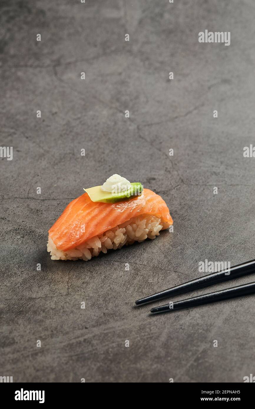 High angle of palatable nigiri sushi with slice of salmon on rice ...