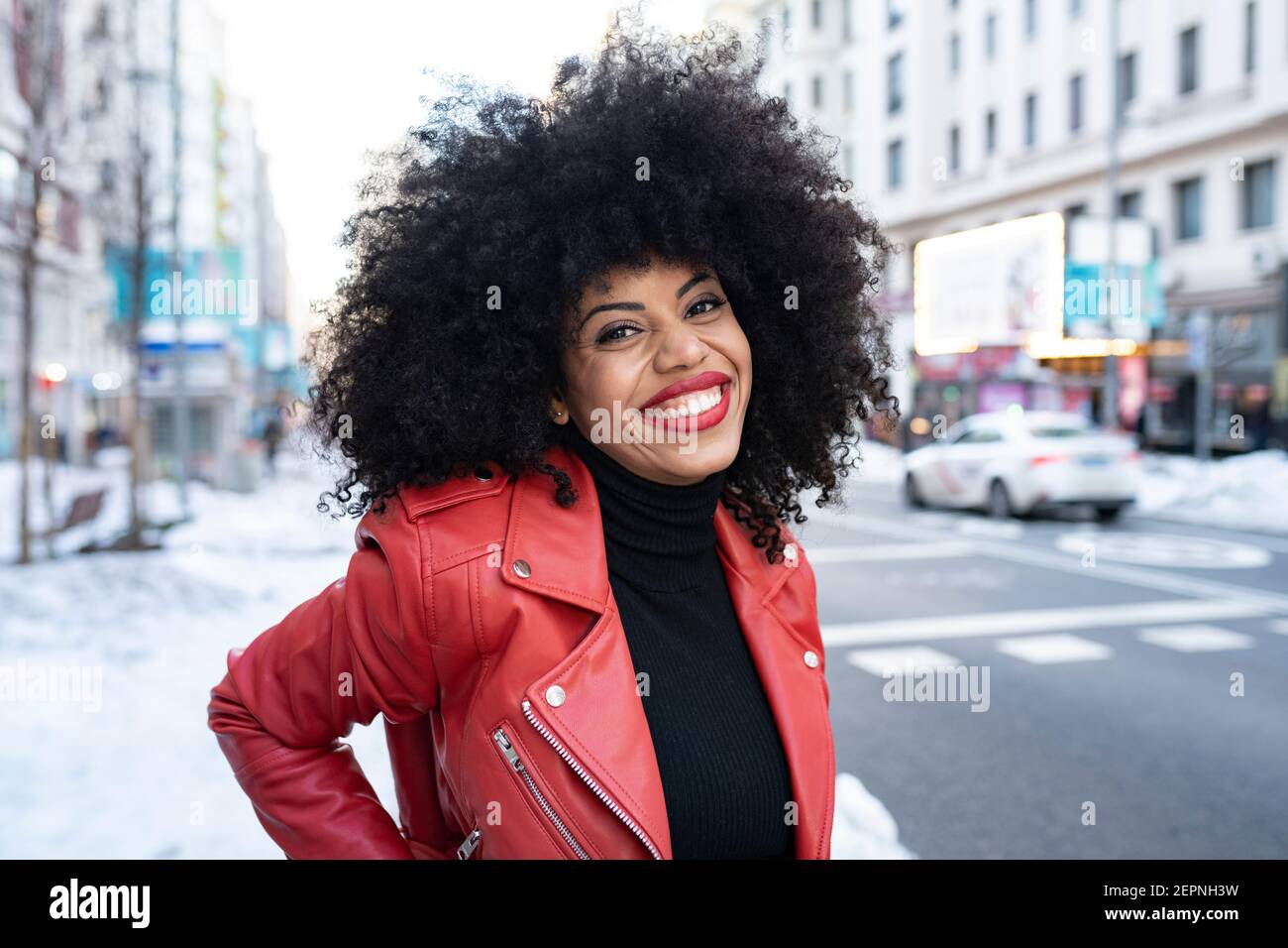 Black Woman with afro hair on the street and smiling at camera Stock ...