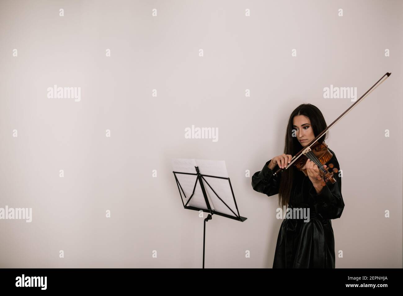 Serious artist playing stringed musical instrument while practicing ...