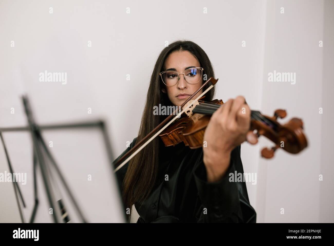 Serious artist playing stringed musical instrument while practicing ...