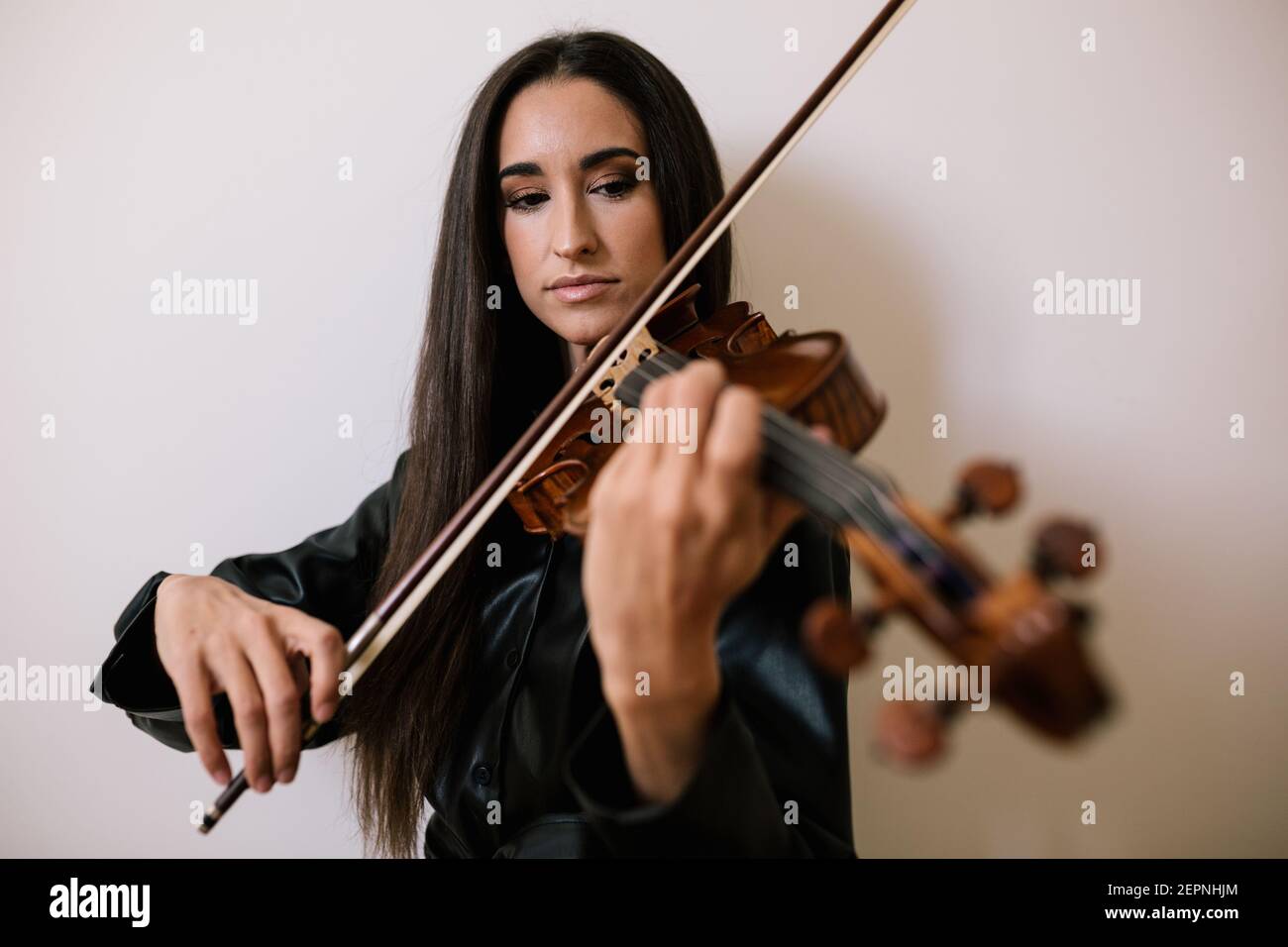Serious artist playing stringed musical instrument while practicing ...