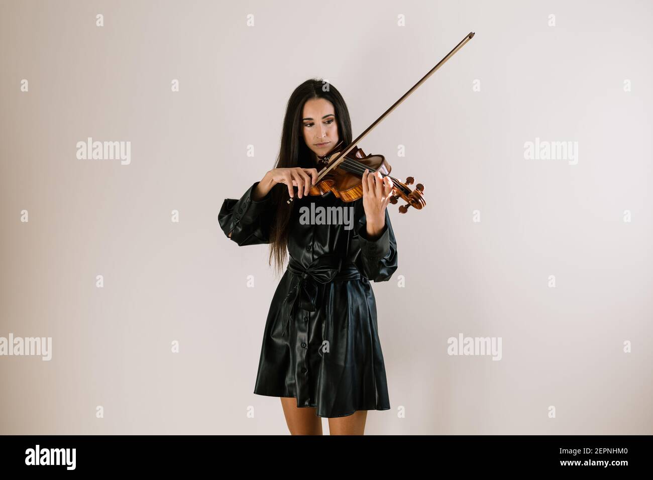 Serious artist playing stringed musical instrument while practicing ...