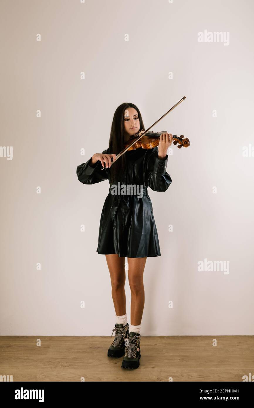 Serious artist playing stringed musical instrument while practicing ...