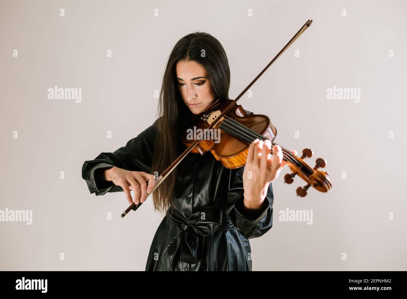 Serious artist playing stringed musical instrument while practicing ...