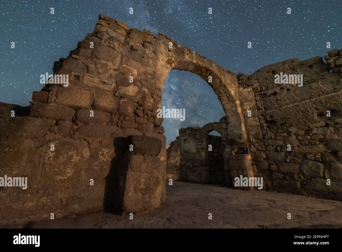 Milky Way galaxy through arch entrance of old ruined castle at night ...