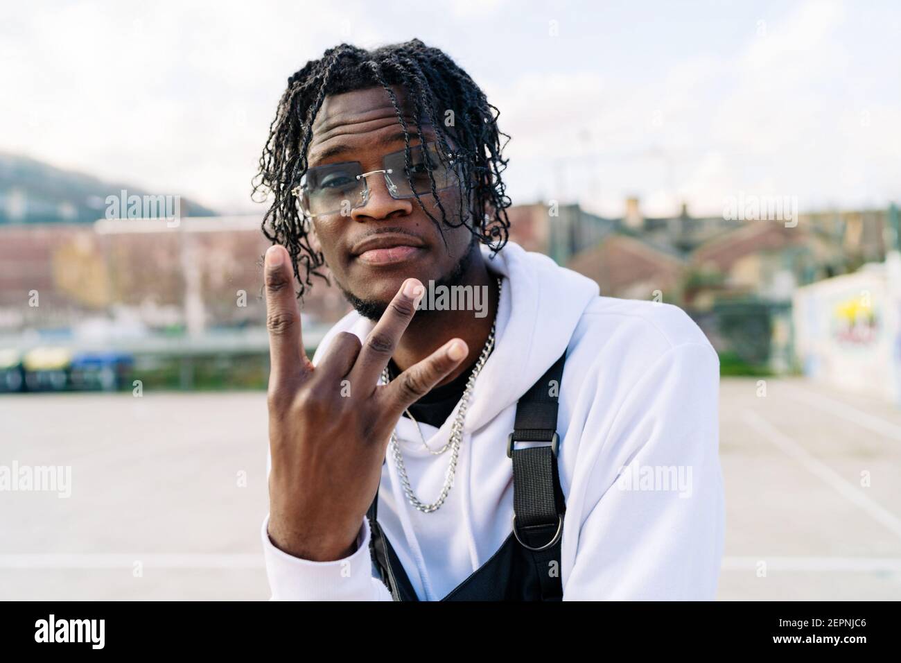 Trendy African American male in sunglasses with Afro braids ...