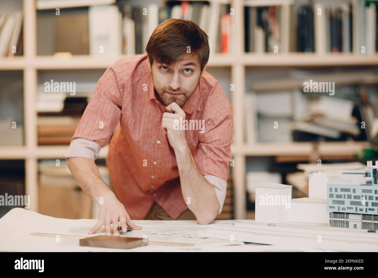 Architect with blueprints and layout design project looking to camera ...