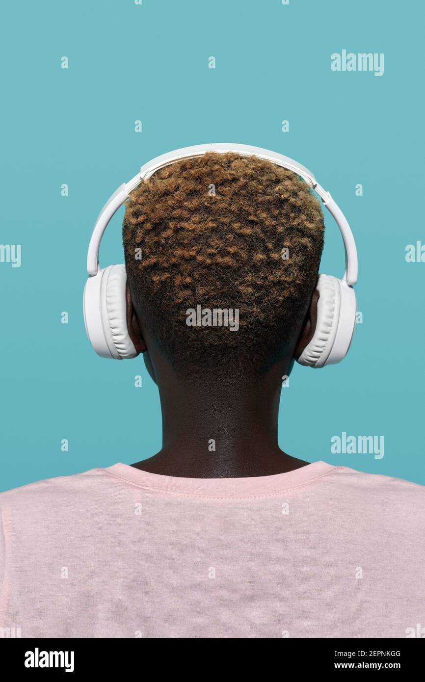 Back view of faceless African American female with short hair listening ...