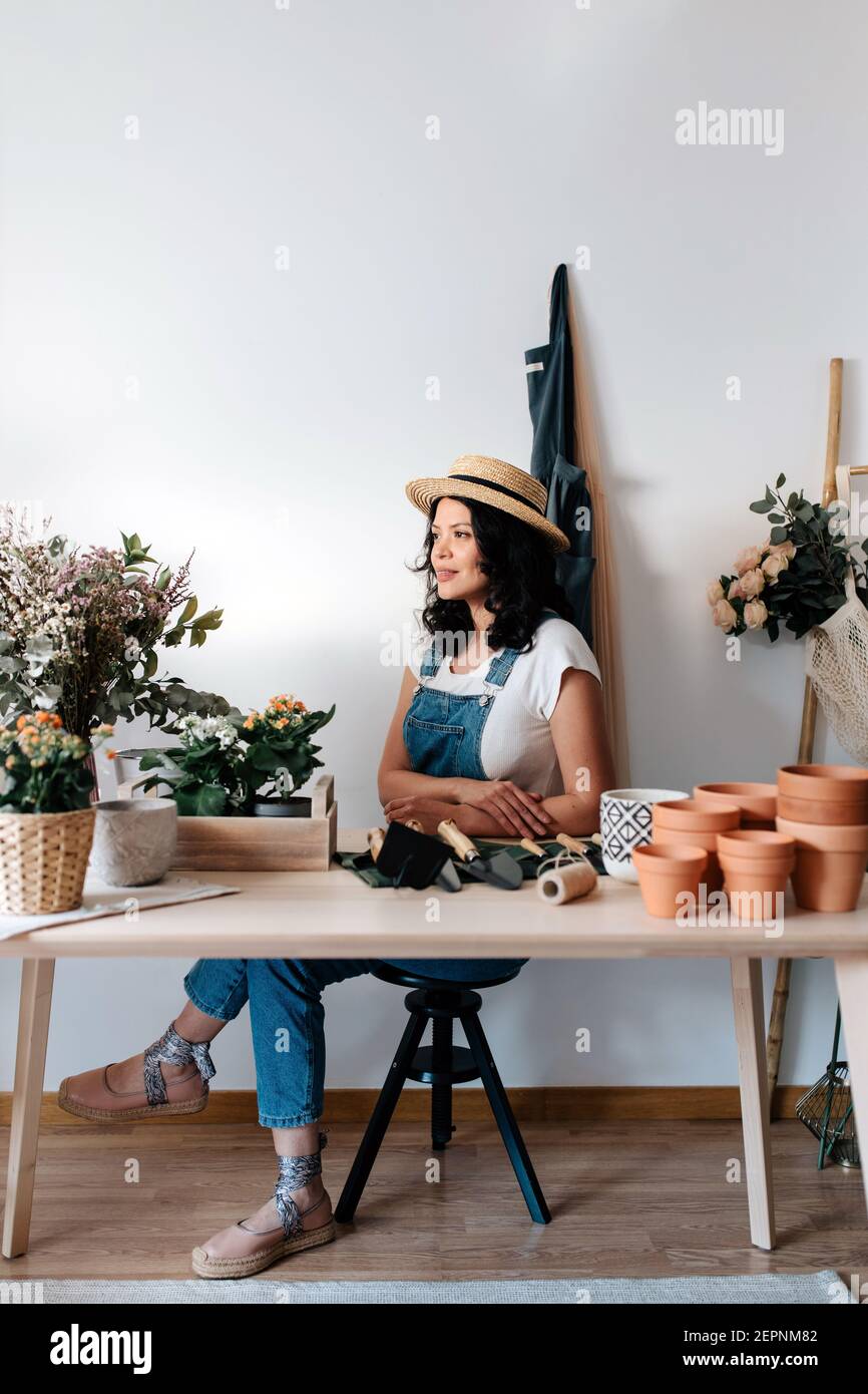 Smiling middle aged female with red bell paper leek and cucumbers ...