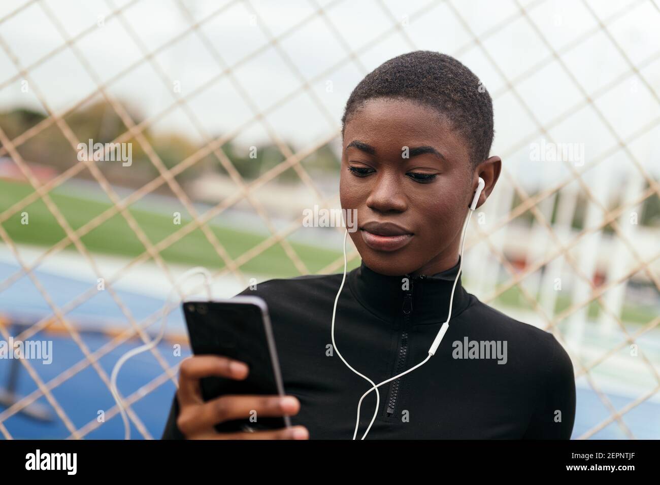 Low angle of confident cheerful African American male in formal suit ...