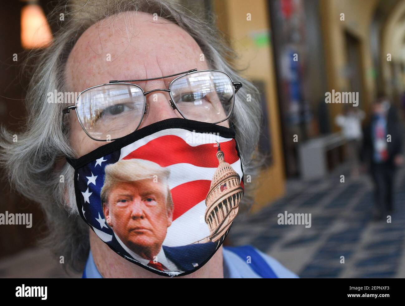 Robert Paxton poses wearing a Trump face mask at the 2021 Conservative ...