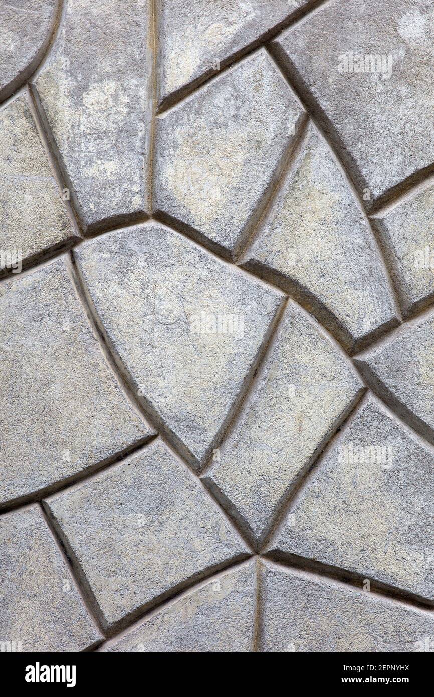 Closeup of grey stone wall made of of irregular geometric shapes Stock ...